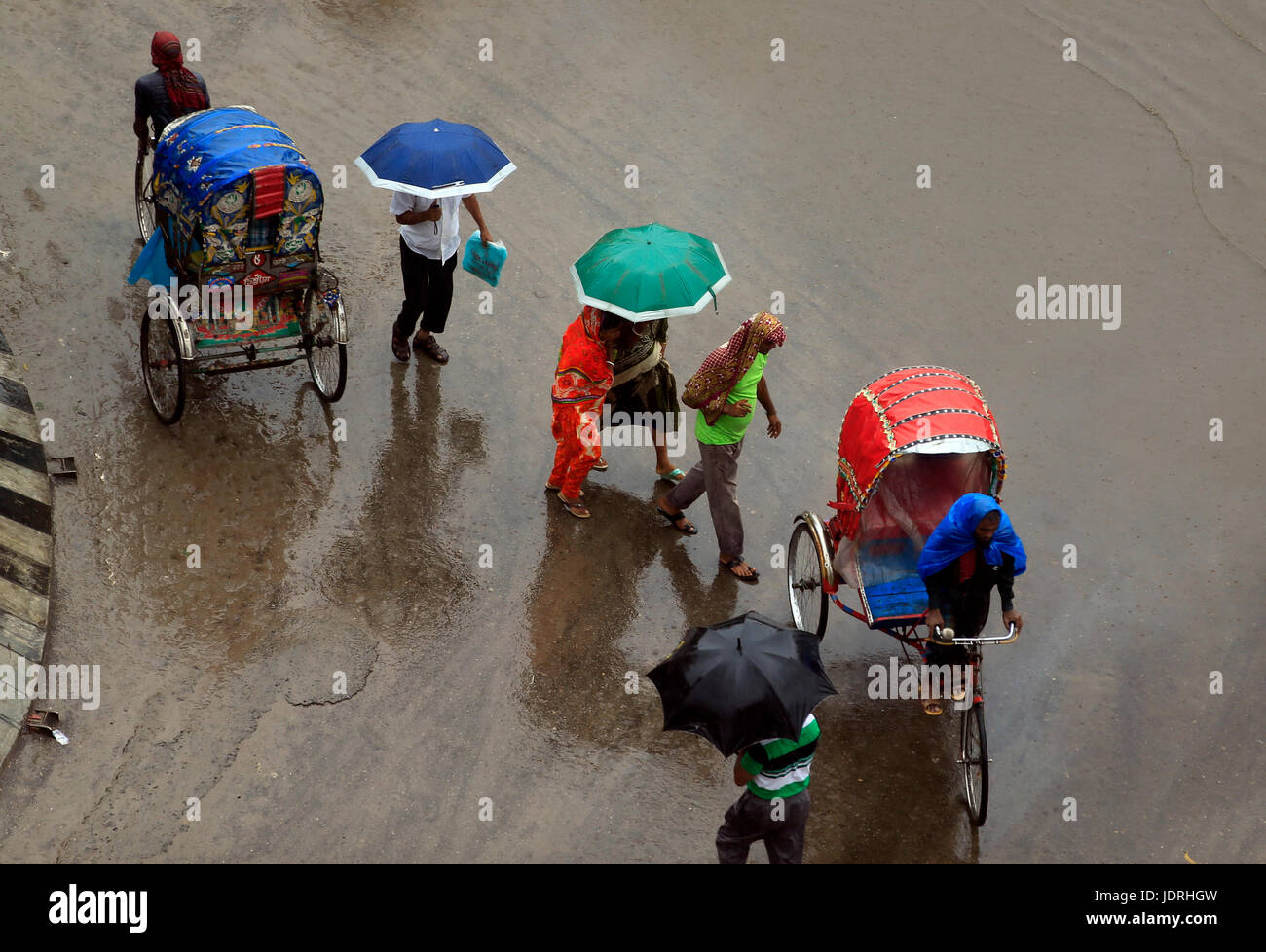 Commuters walk through the heavy rain in the capitals and several other ...
