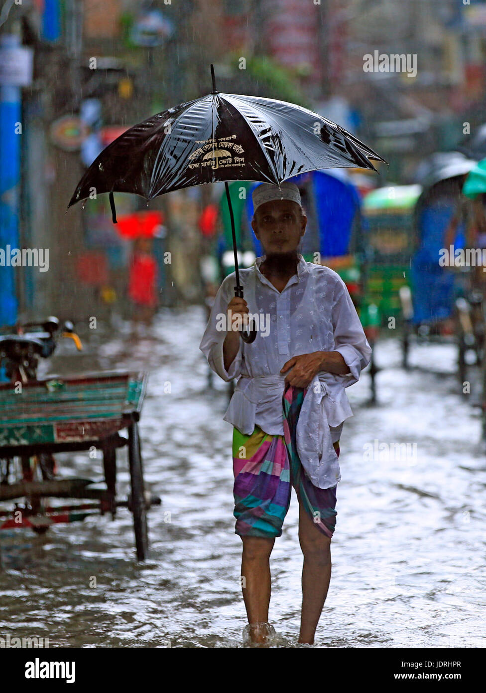 Commuters walk through the heavy rain in the capitals and several other ...