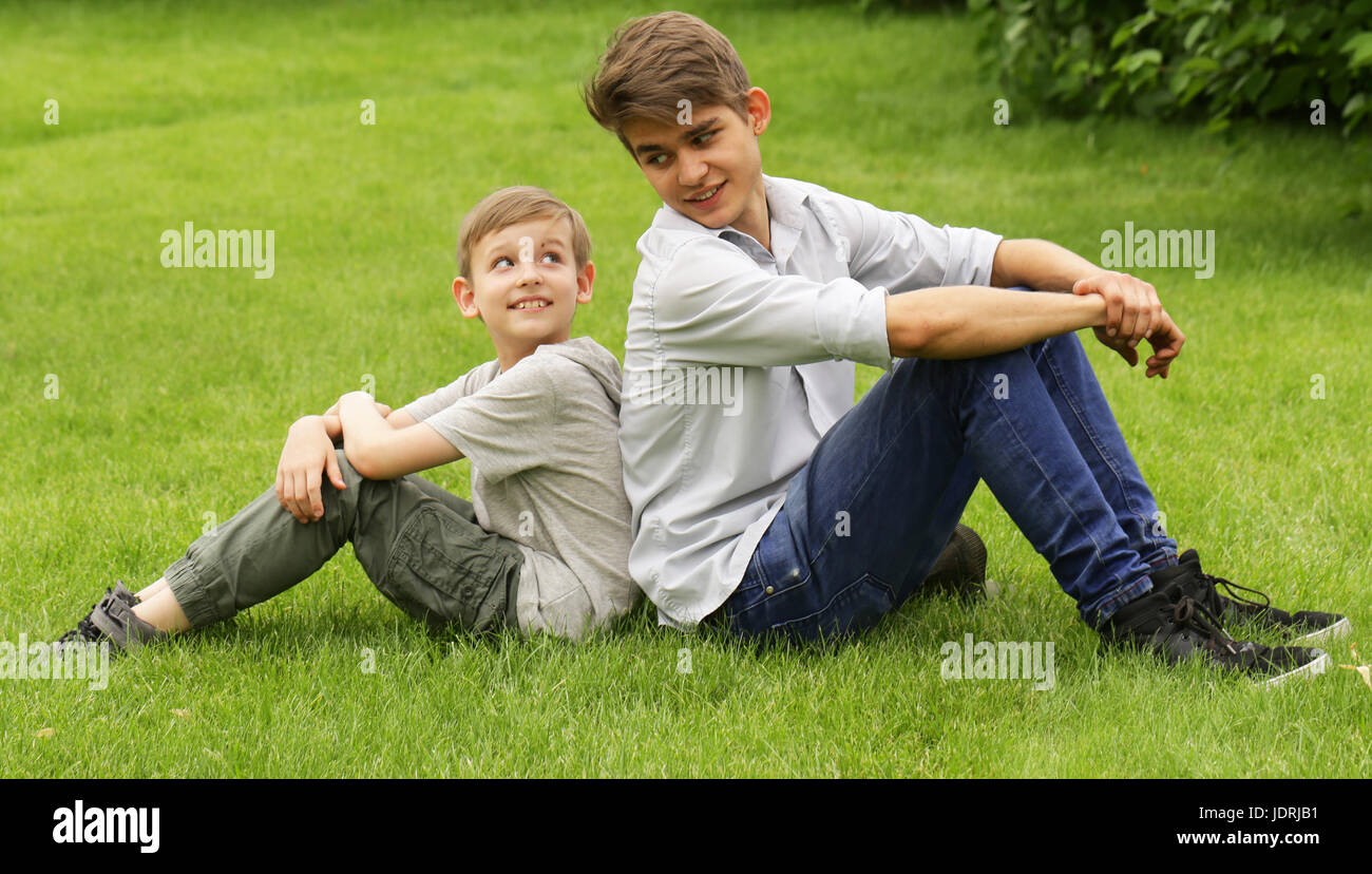 Two brothers have fun in the park - summer time, picnic Stock Photo - Alamy