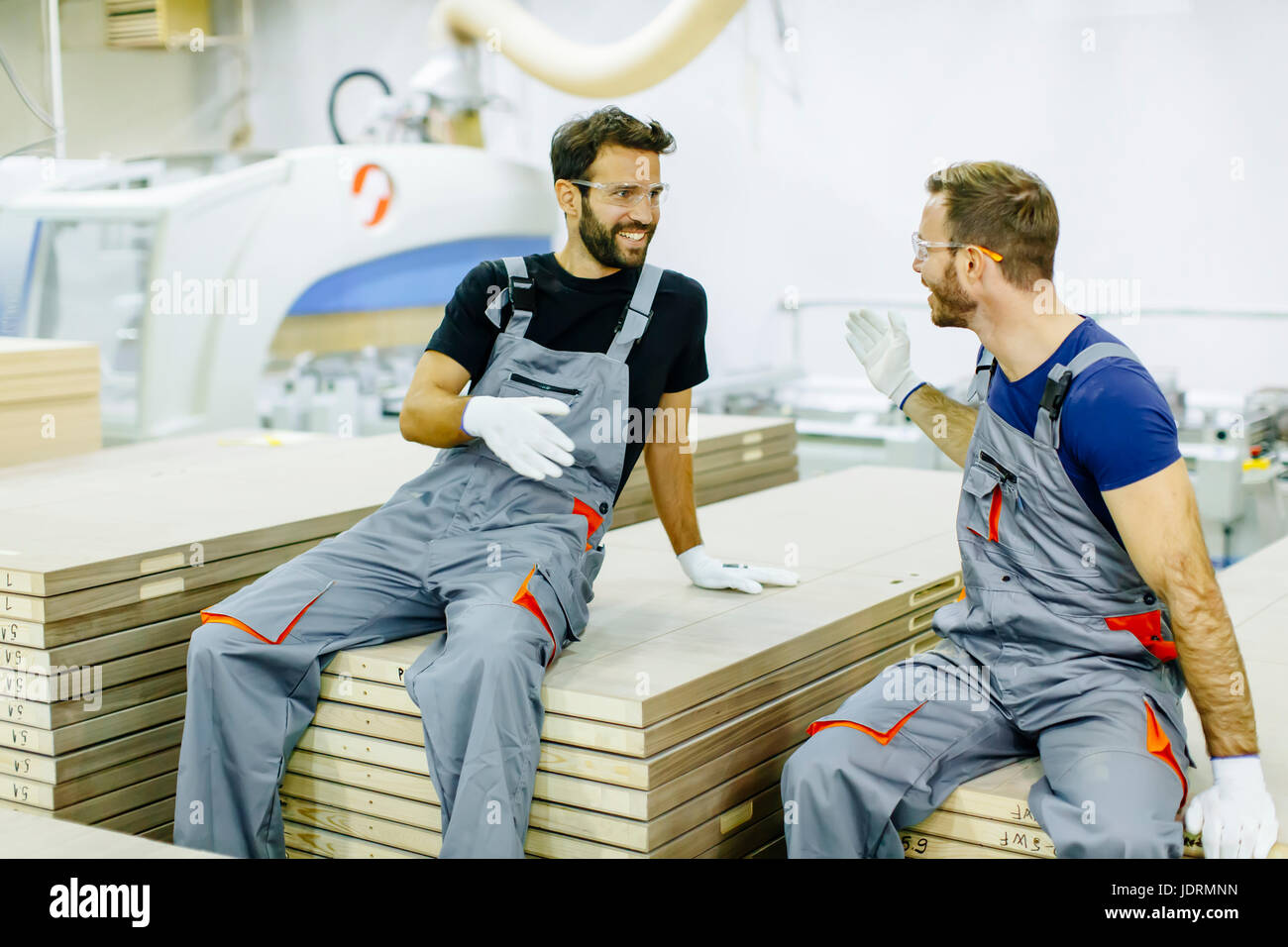 Two male workers working in furniture industry and creating custom ...