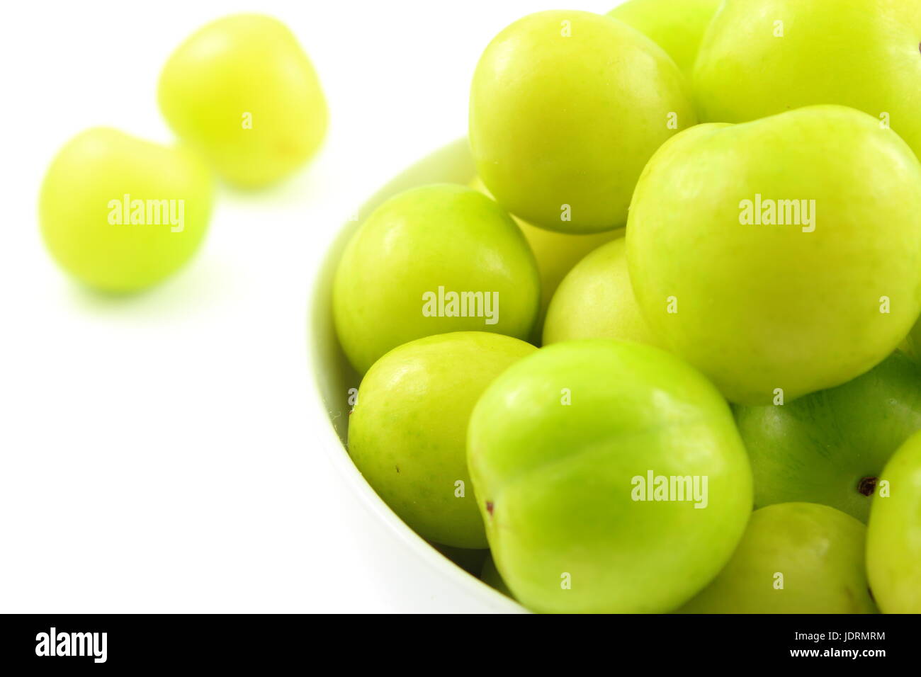 composition of fresh turkish can erik plum fruits in a small white bowl ...