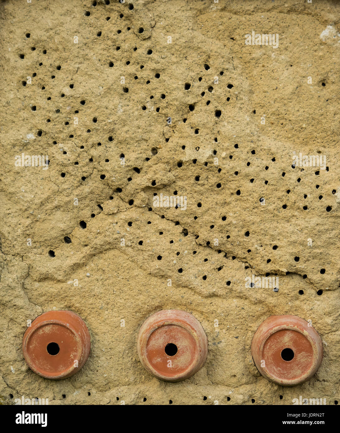Clay pots in clay wall Stock Photo - Alamy