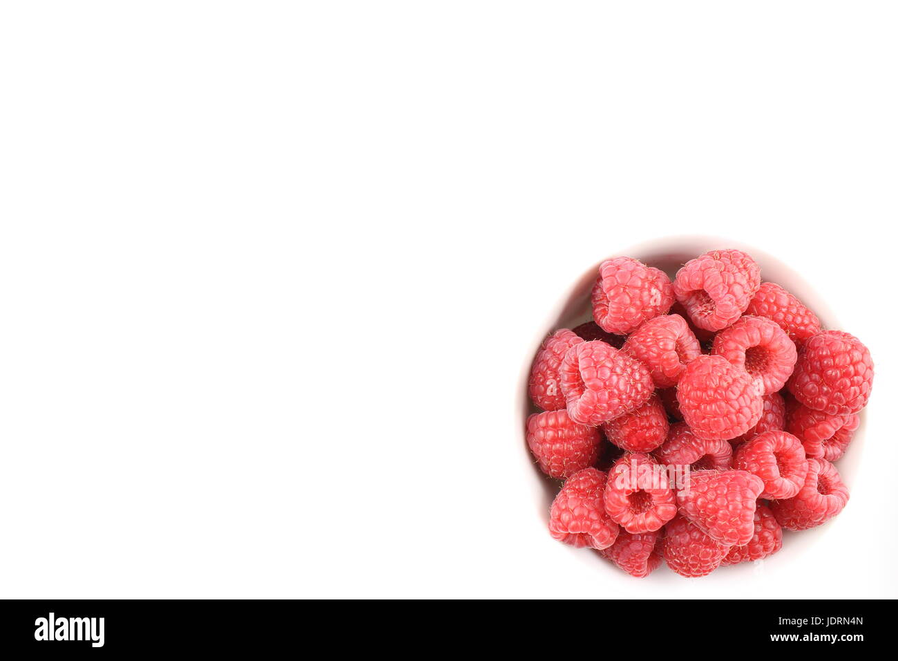 fresh red raspberry fruits in a small white bowl Stock Photo - Alamy
