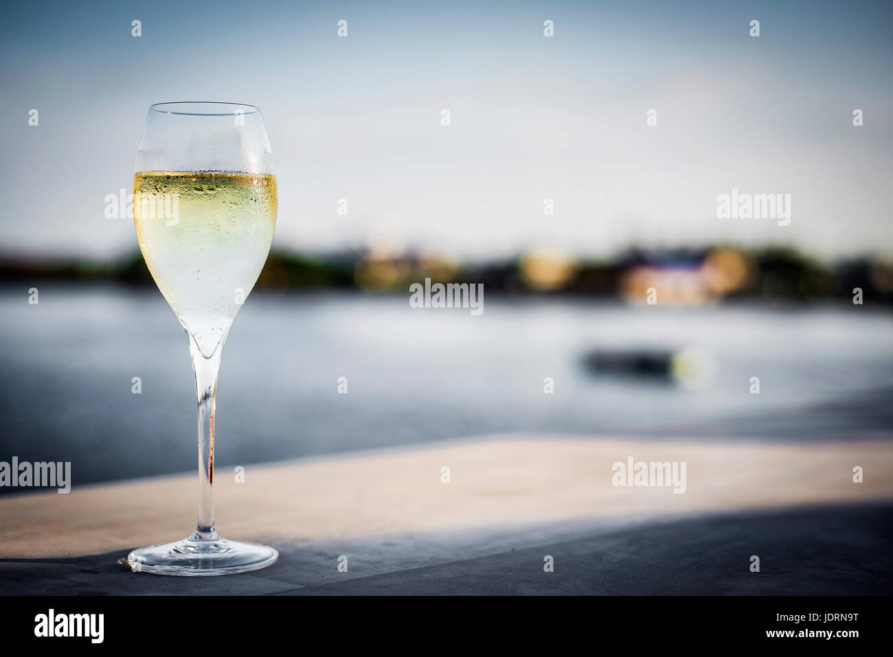 glass of sparking champagne wine at modern outdoor bar at sunset Stock ...