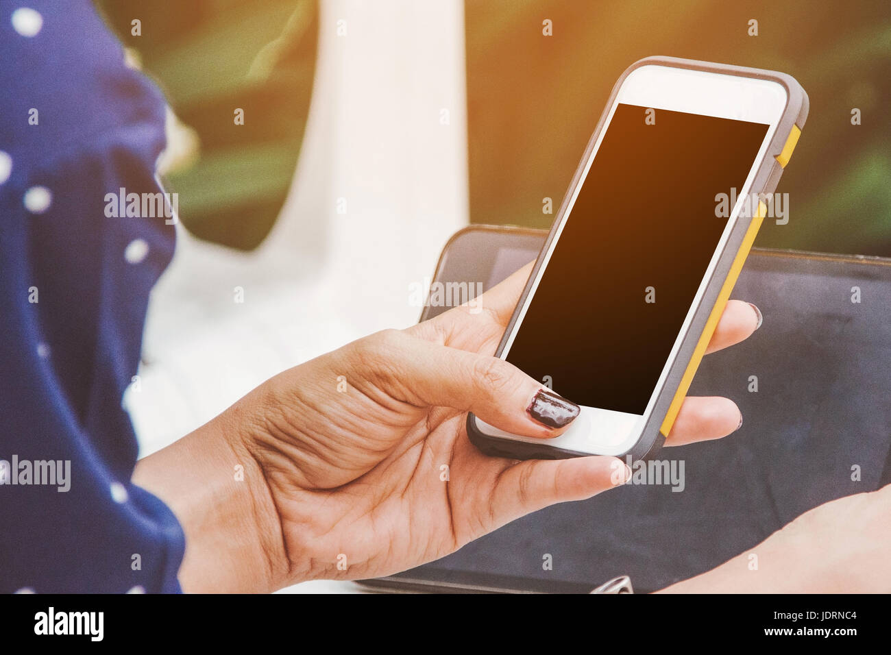 woman touch screen on smartphone with nature background. subject is ...