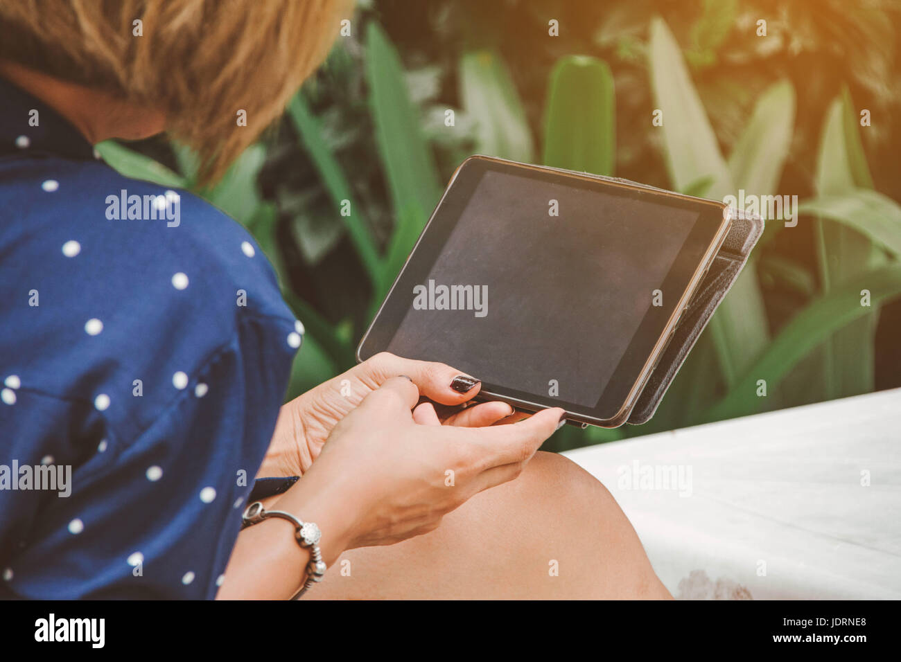 woman touch screen on smartphone with nature background. subject is ...