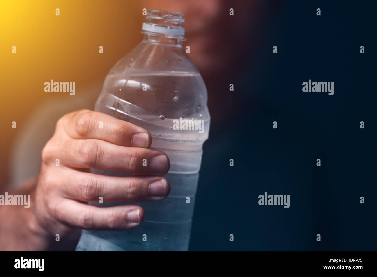 Man with bottle of fresh drinking water for refreshment and ...