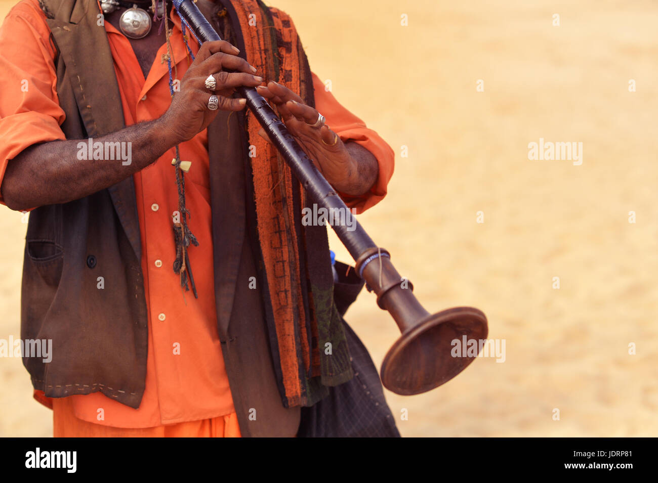 Man in traditional clothing playing on ethnic musical instrument Stock ...