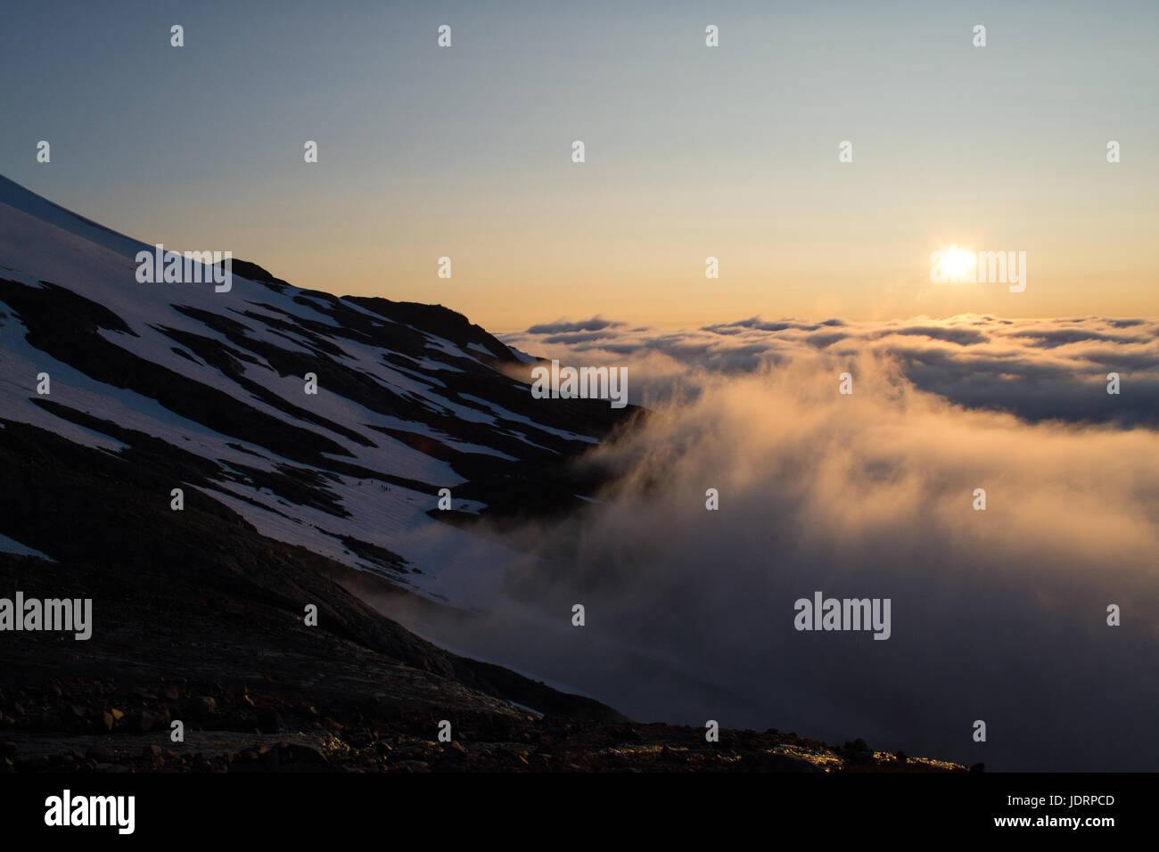 Clouds glowing in the last light of the sun Stock Photo - Alamy