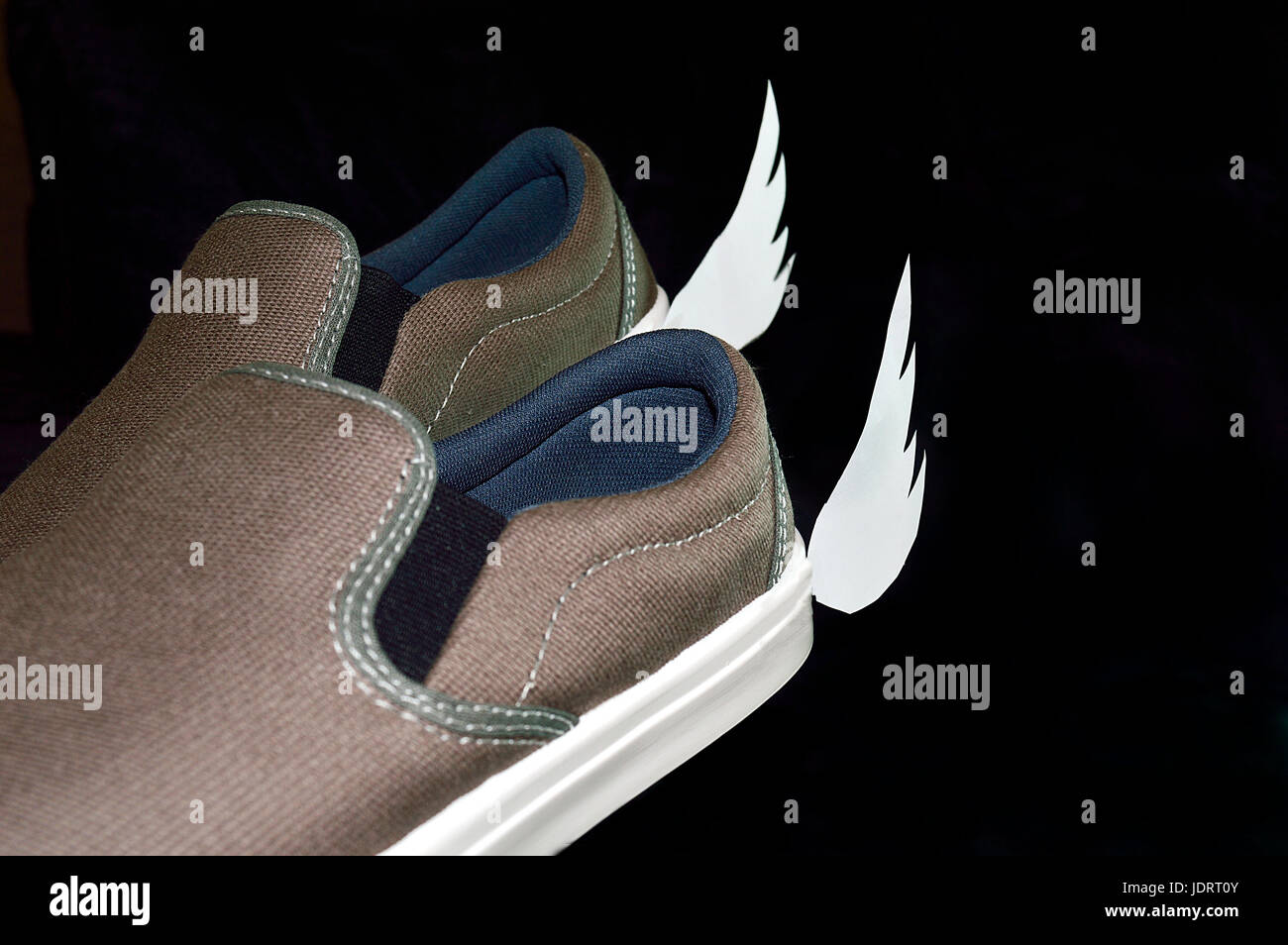 Brown shoes with winds isolated on a black background Stock Photo - Alamy