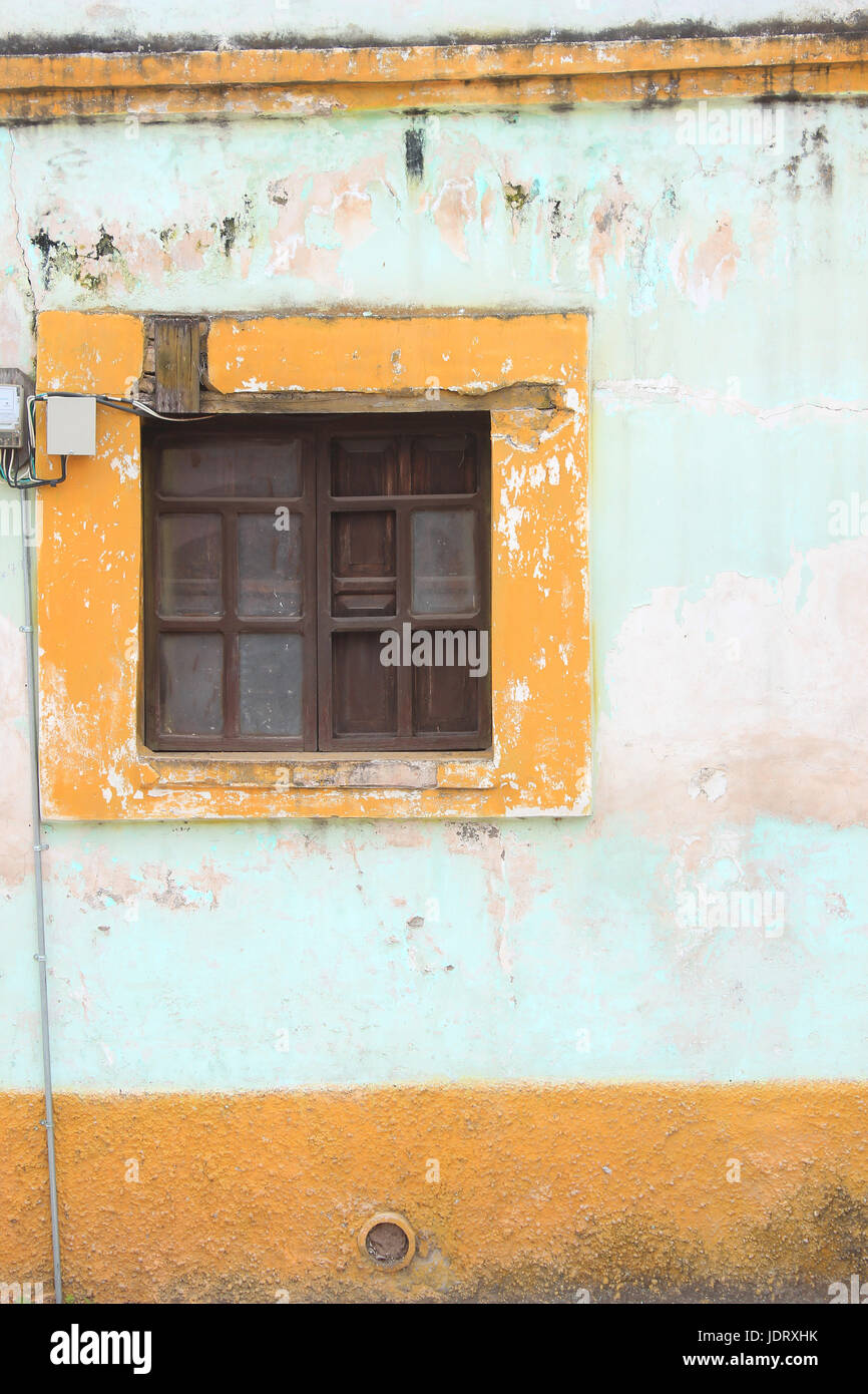 A window in a plaster covered wall in a building in Cotacachi, Ecuador ...
