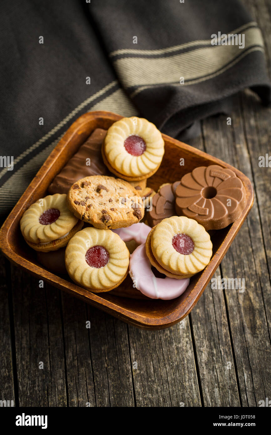 Various sweet biscuits on old wooden table Stock Photo - Alamy