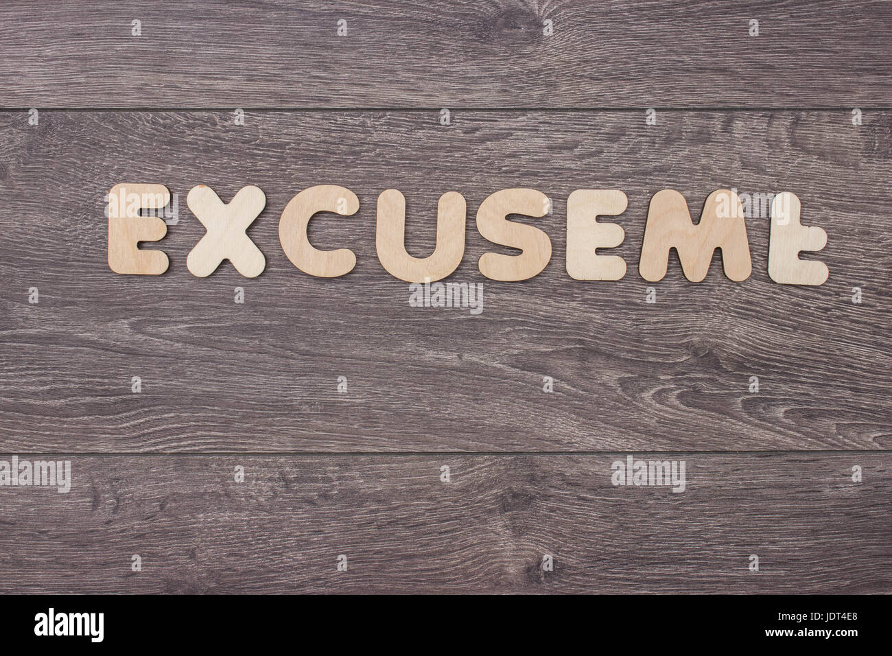 Words Excuse me made with wooden letters over the wooden board surface ...