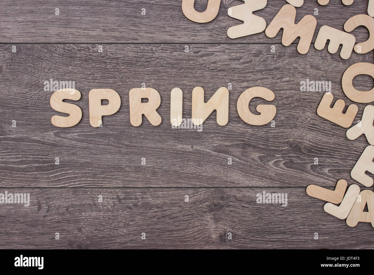 Word Spring made with wooden letters next to a pile of other letters ...