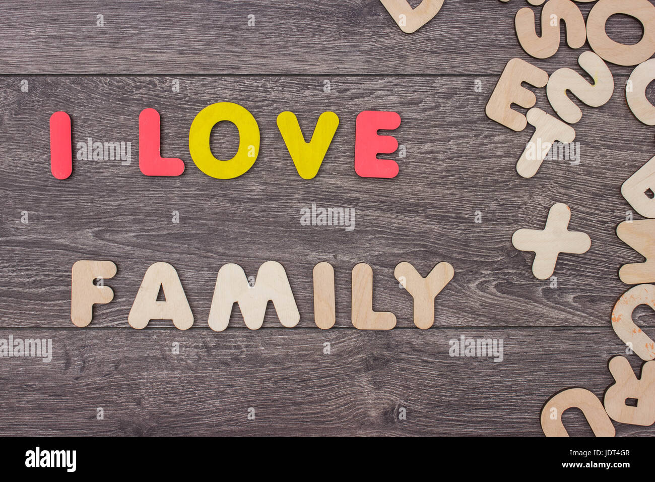 Words I Love Family made with wooden letters next to a pile of other ...