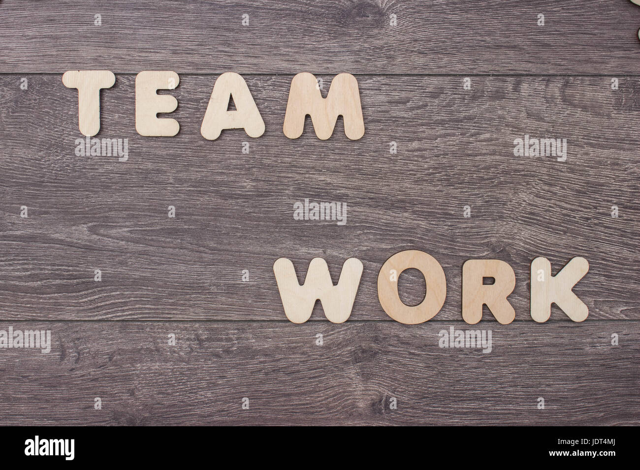 Word Team Work made with wooden letters over the wooden board surface ...
