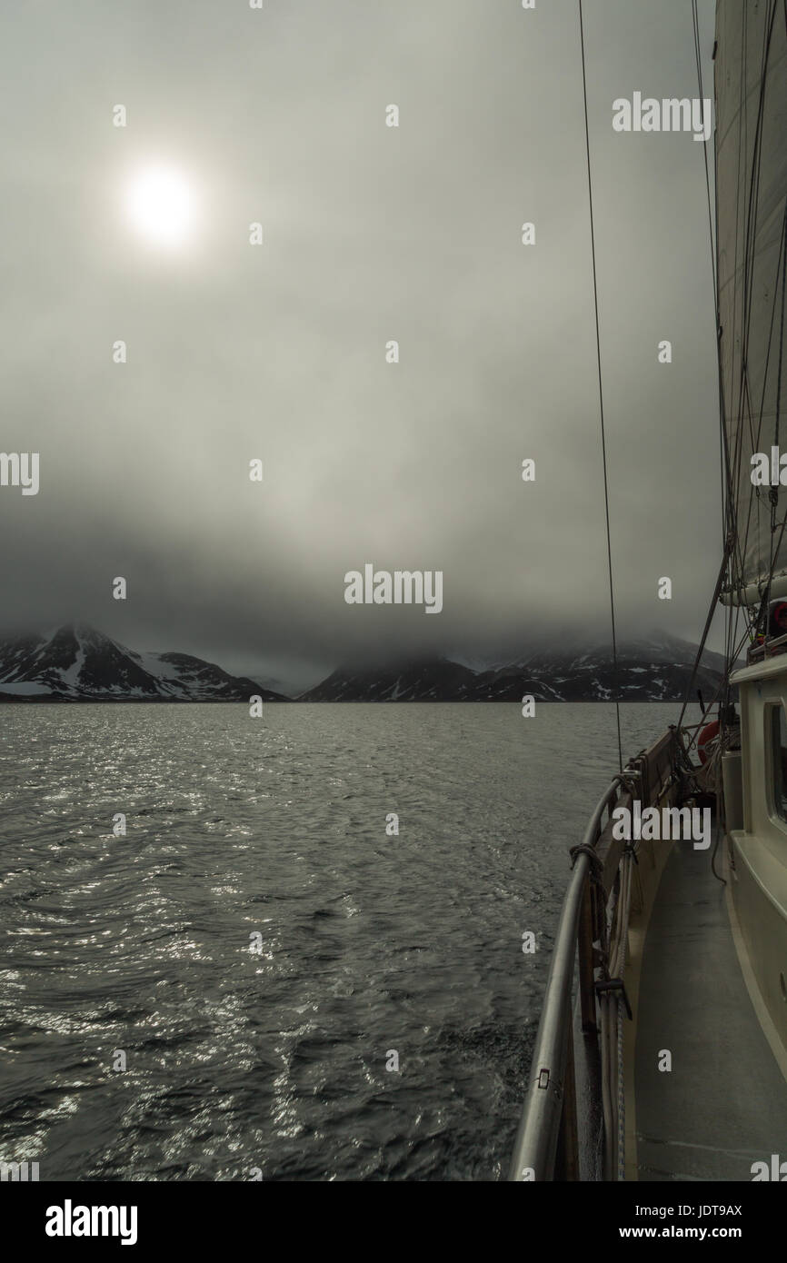 A pale weak sun shows through a layer of overcast offshore from ...