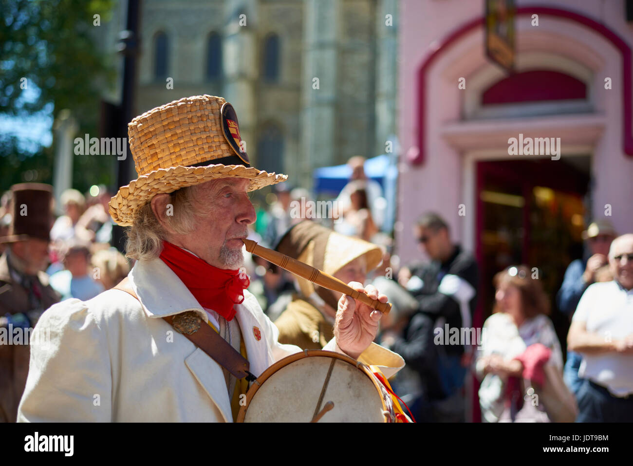 Man in a wicker top hat, blowing a whistle on the parade at the Dickens ...