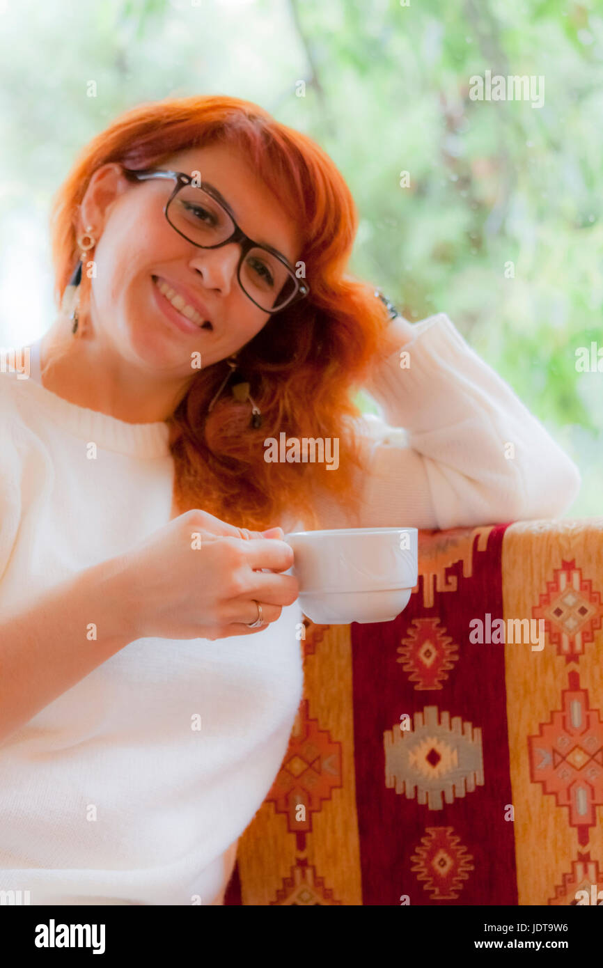 Young smiling girl is drinking tea Stock Photo - Alamy