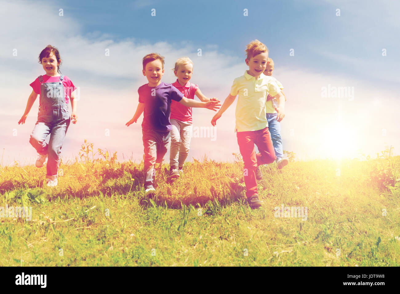 group of happy kids running outdoors Stock Photo - Alamy