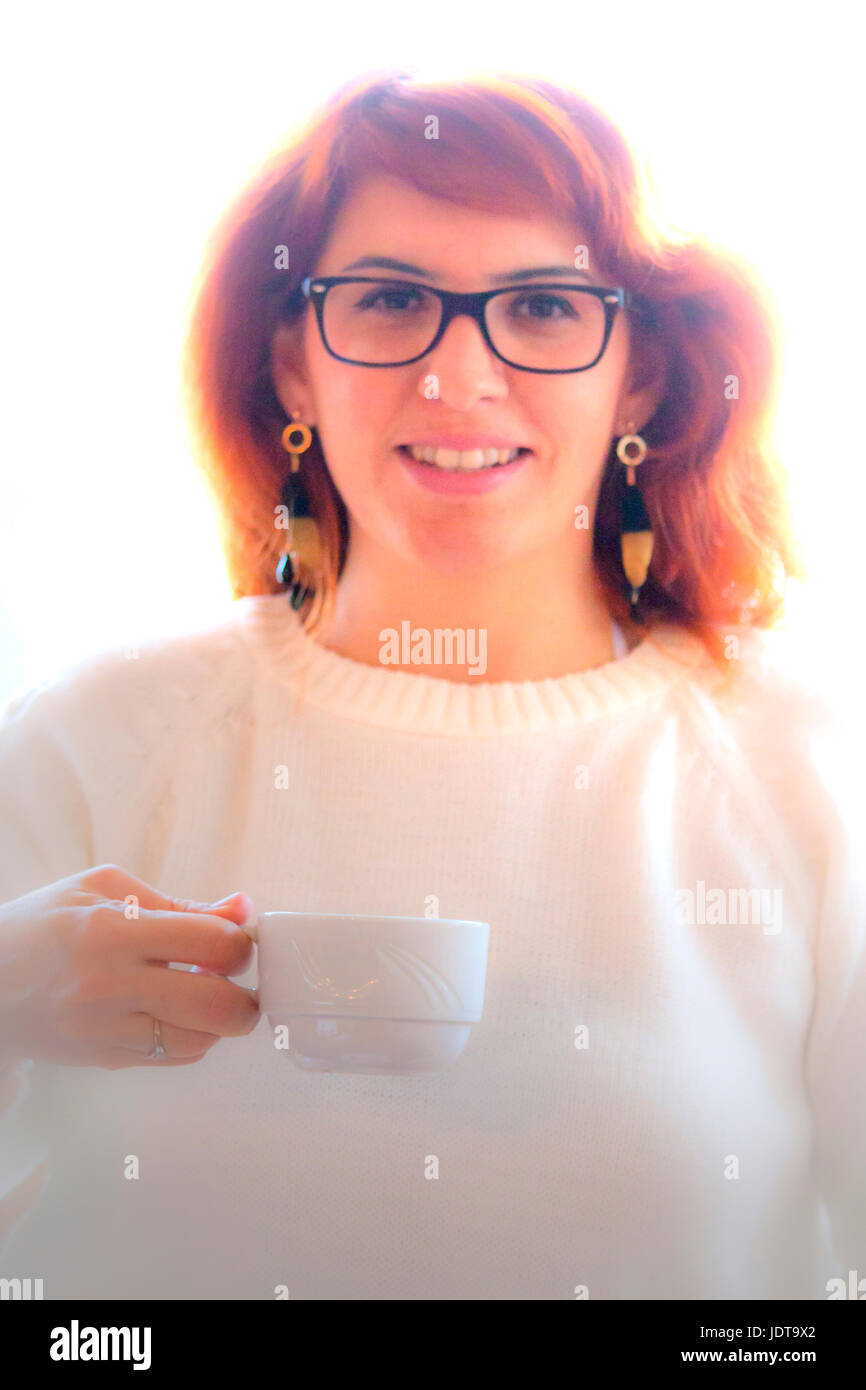 Young smiling girl is drinking tea Stock Photo - Alamy