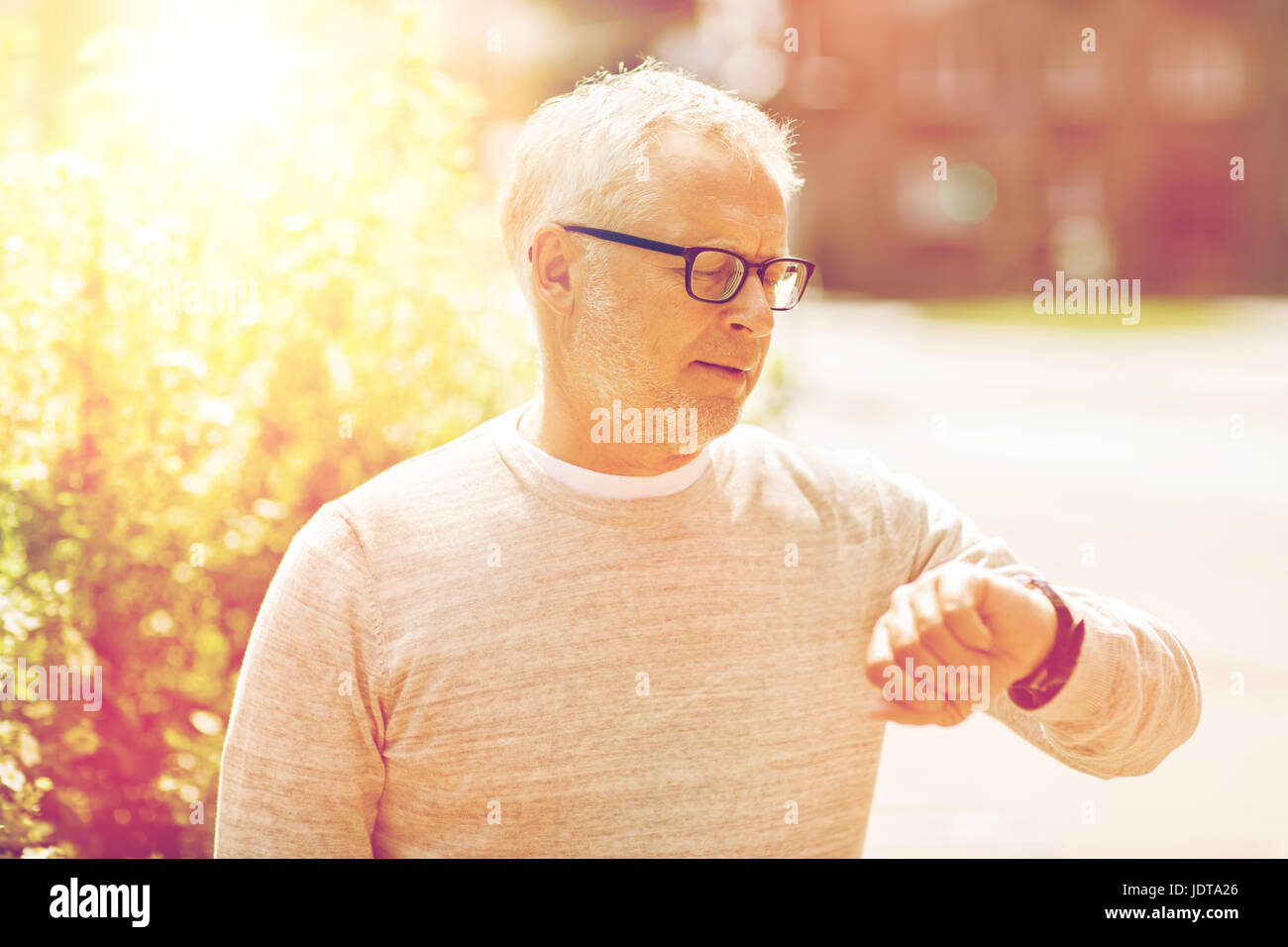 senior man checking time on his wristwatch Stock Photo - Alamy