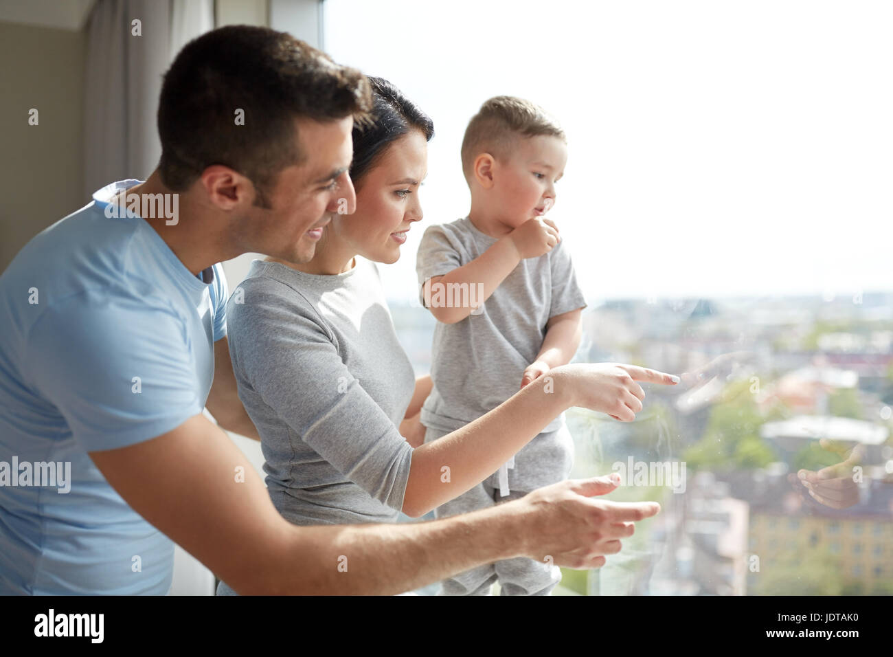 happy family looking through window at home Stock Photo - Alamy