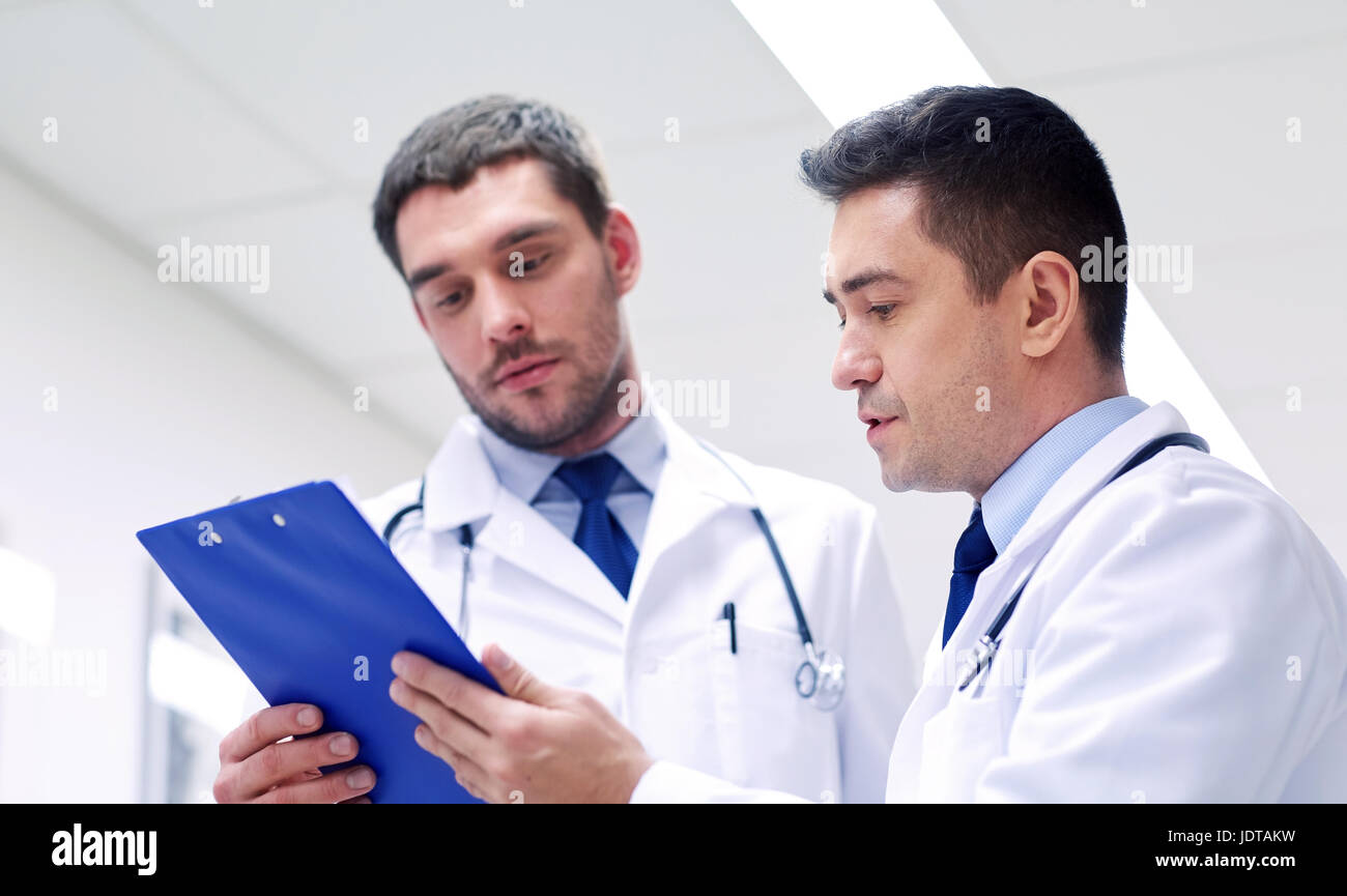 two doctors at hospital with clipboard Stock Photo - Alamy