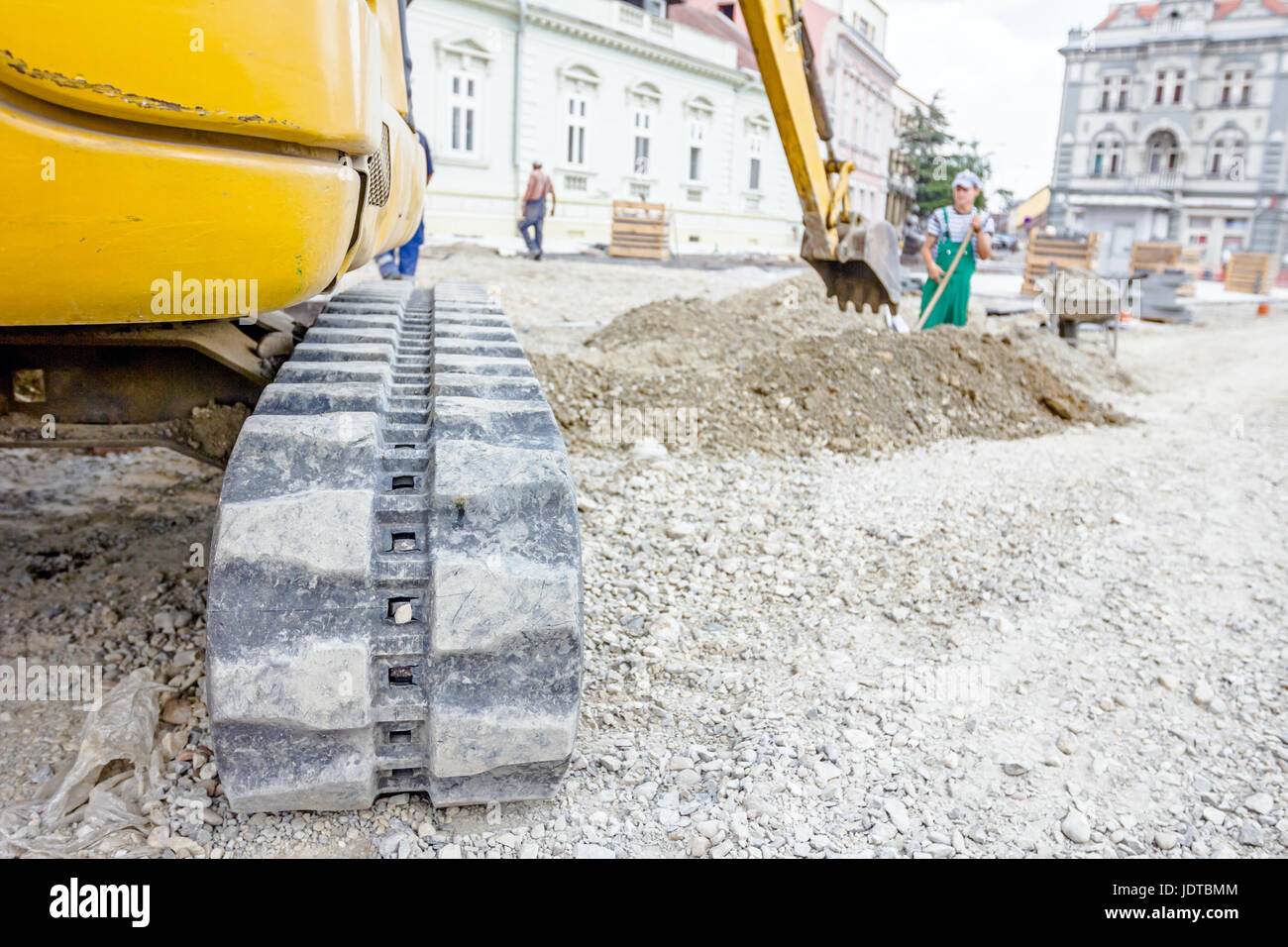 Small excavator is excavating soil at construction site, project in ...