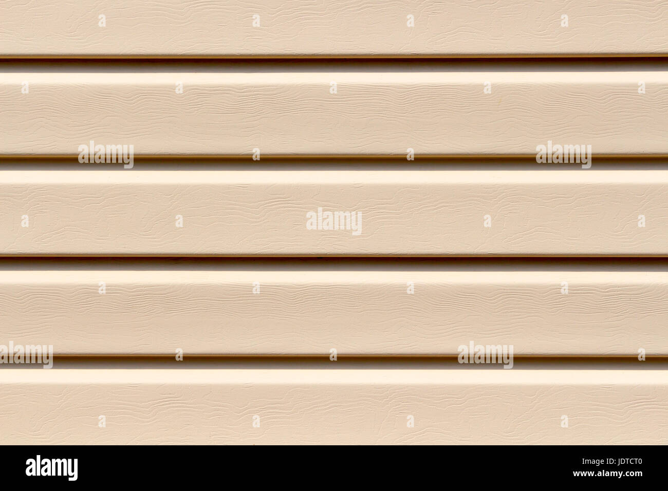 The surface of the beige plastic siding close up as a background Stock ...