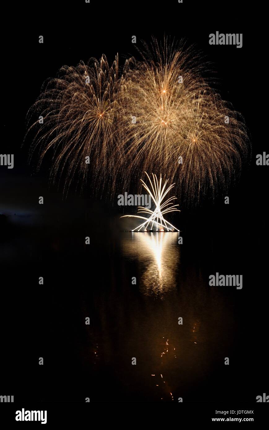 Firework. Beautiful colorful fireworks on the water surface with a ...