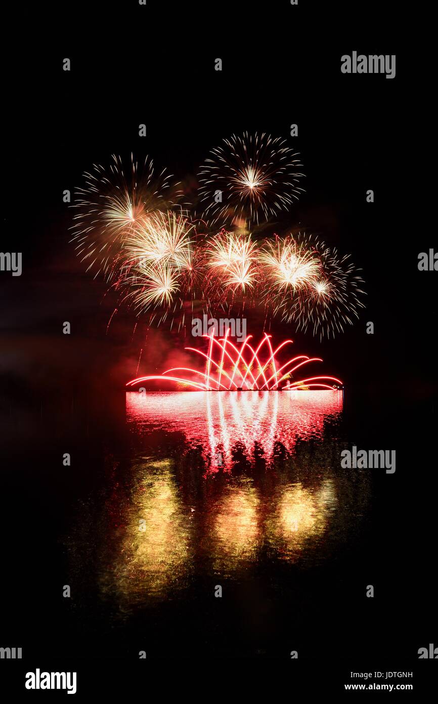 Firework. Beautiful colorful fireworks on the water surface with a ...