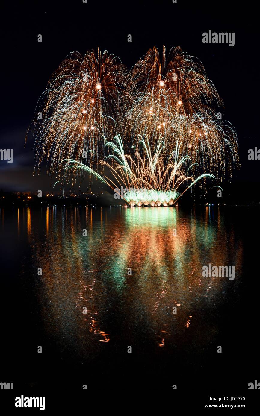 Firework. Beautiful colorful fireworks on the water surface with a ...
