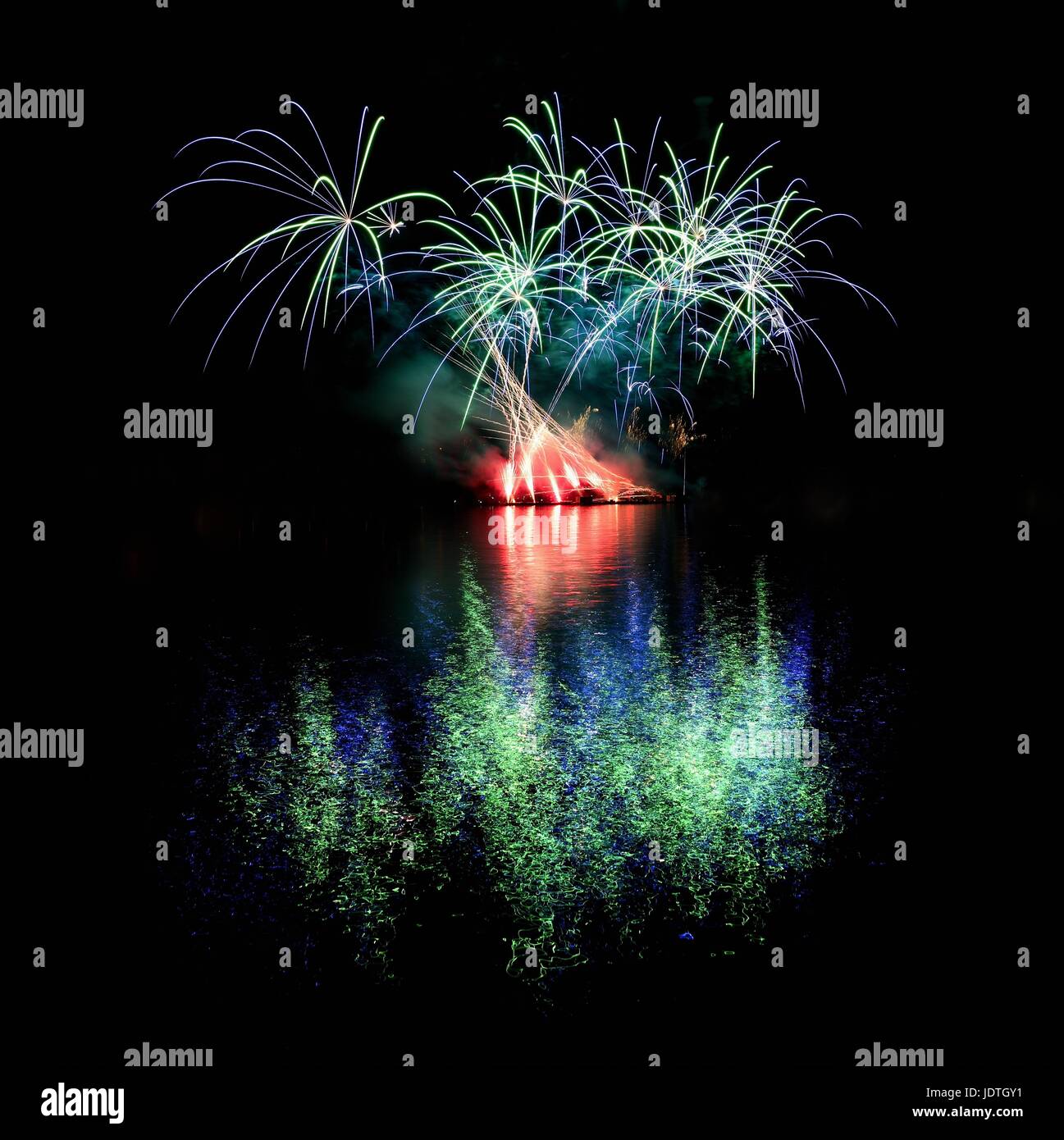 Firework. Beautiful colorful fireworks on the water surface with a ...