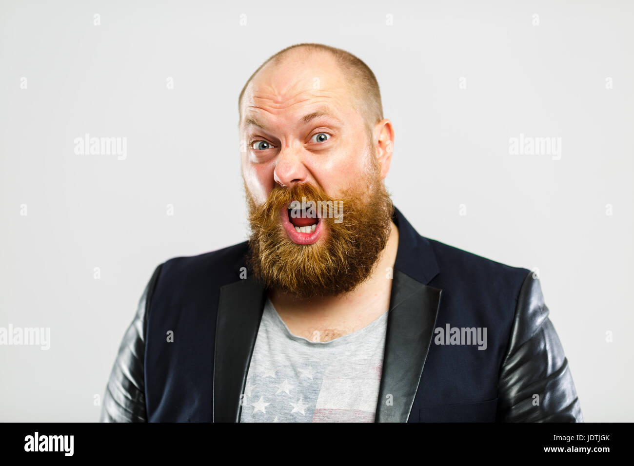 Screaming brutal man with beard on empty gray background Stock Photo ...
