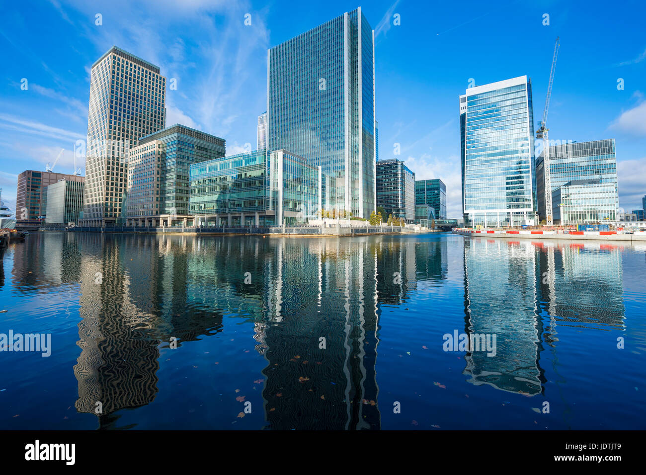 Shiny Canary Wharf skyscrapers towering above and reflecting in the ...