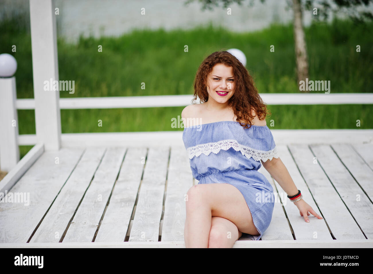 Portrait of a fabulous young girl wearing chic outfit posing on a white ...