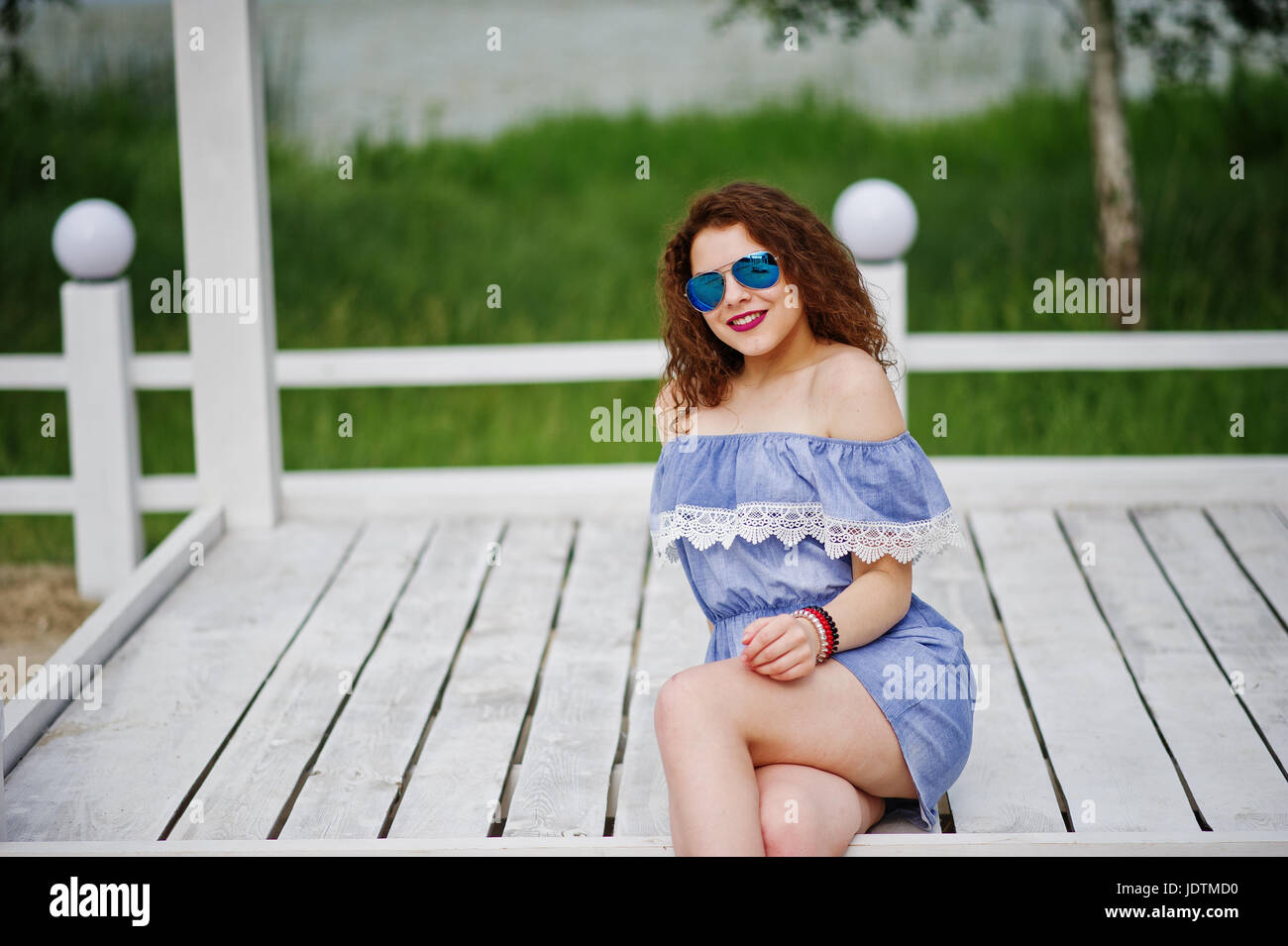 Portrait of a fabulous young girl wearing chic outfit posing on a white ...