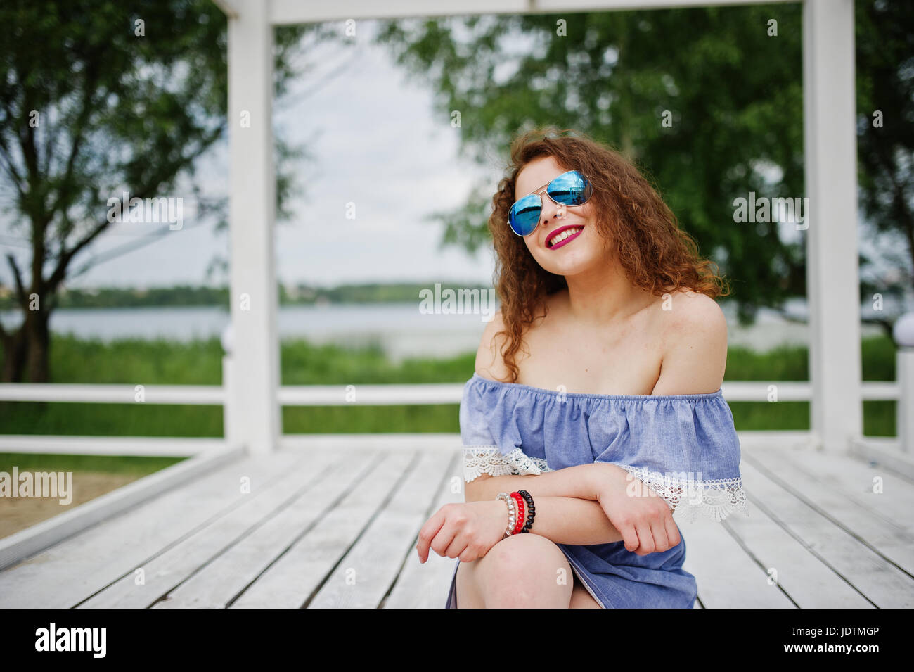 Portrait of a fabulous young girl wearing chic outfit posing on a white ...