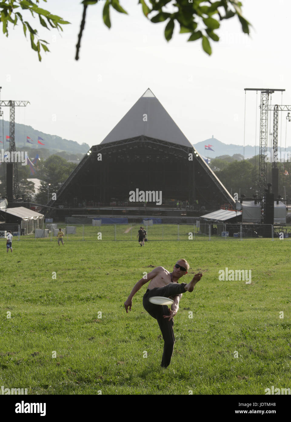 A man playing frisbee in front of the Pyramid stage at the 2017 ...