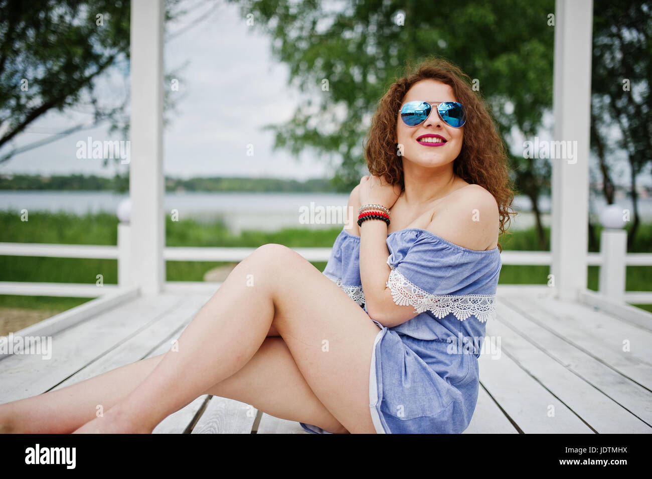 Portrait of a fabulous young girl wearing chic outfit posing on a white ...