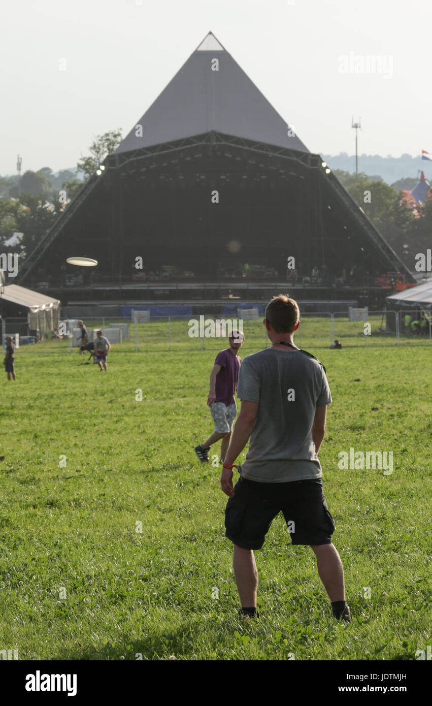 Two men playing frisbee in front of the Pyramid stage at the 2017 ...