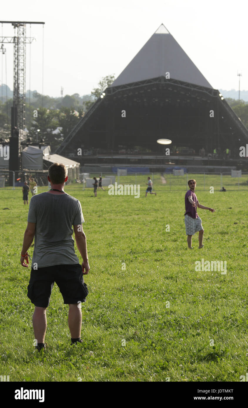 Two men playing frisbee in front of the Pyramid stage at the 2017 ...