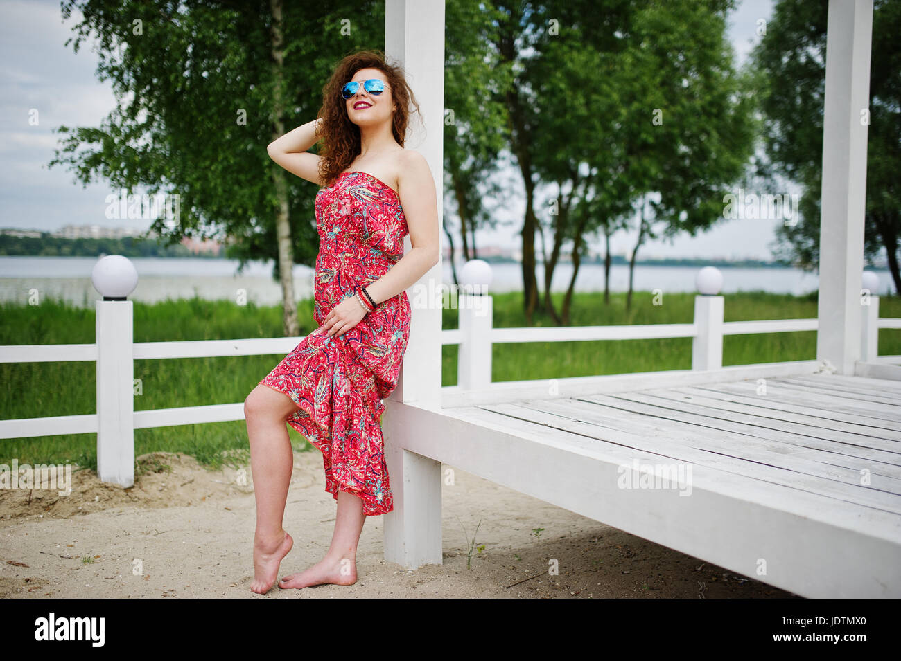 Portrait of a fabulous young girl wearing chic outfit posing on a white ...