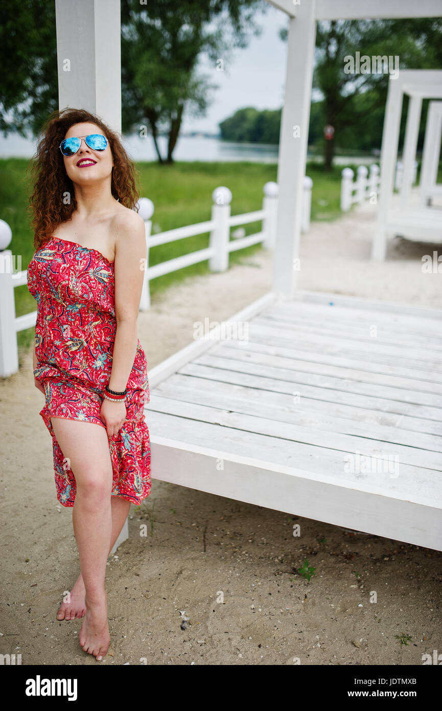 Portrait of a fabulous young girl wearing chic outfit posing on a white ...