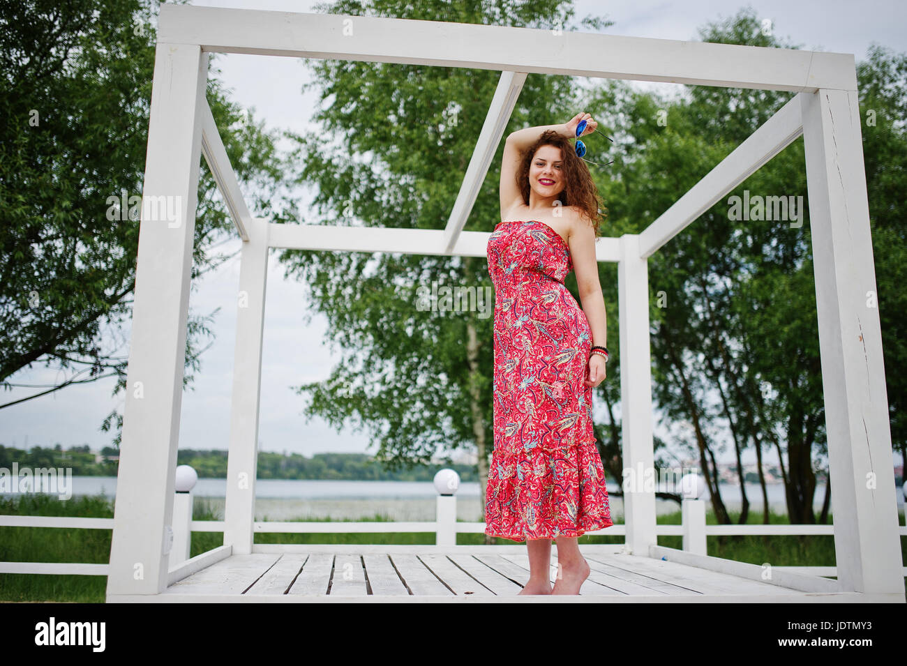 Portrait of a fabulous young girl wearing chic outfit posing on a white ...