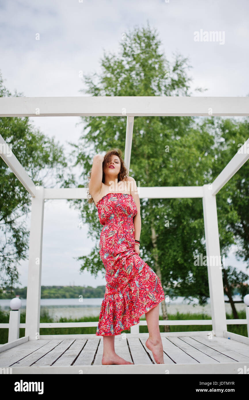 Portrait of a fabulous young girl wearing chic outfit posing on a white ...
