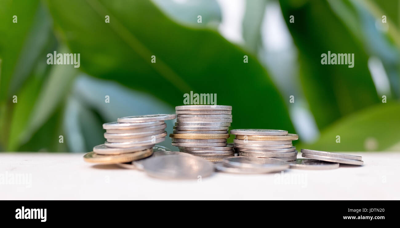 Coins stack on natural background Stock Photo - Alamy