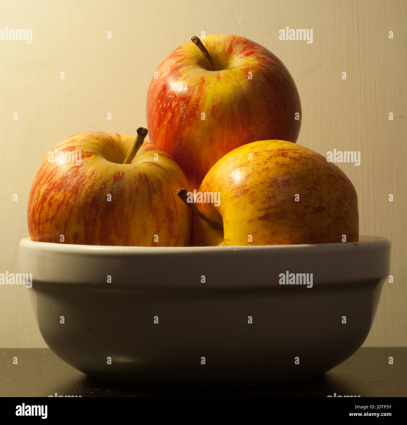 Three Apples in White Bowl Stock Photo - Alamy