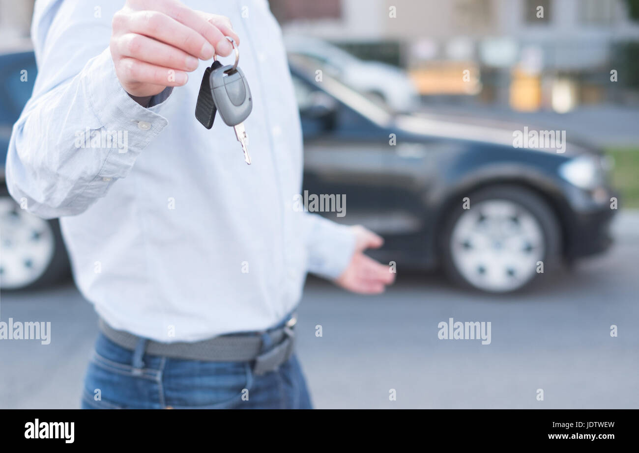 One man holding a car key next to his vehicle Stock Photo - Alamy